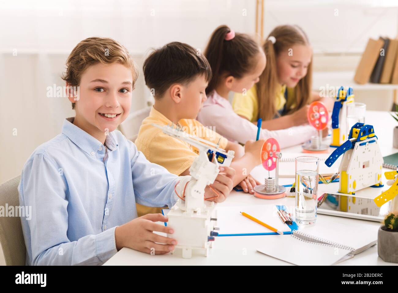 Stem education. Smiling schoolboy showing his robot Stock Photo - Alamy