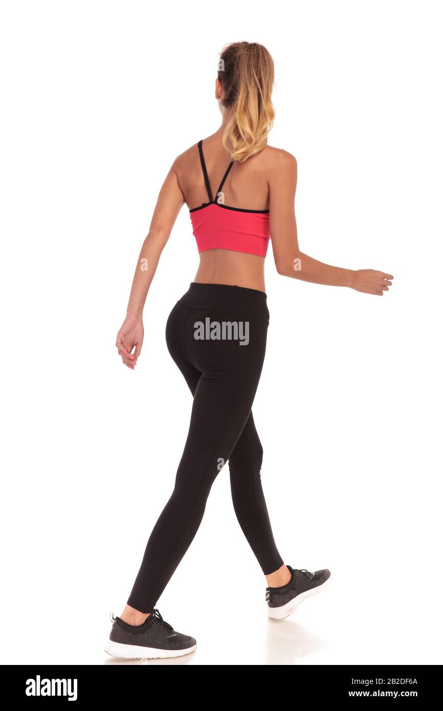back view of a walking woman fitness instructor looking to side on ...