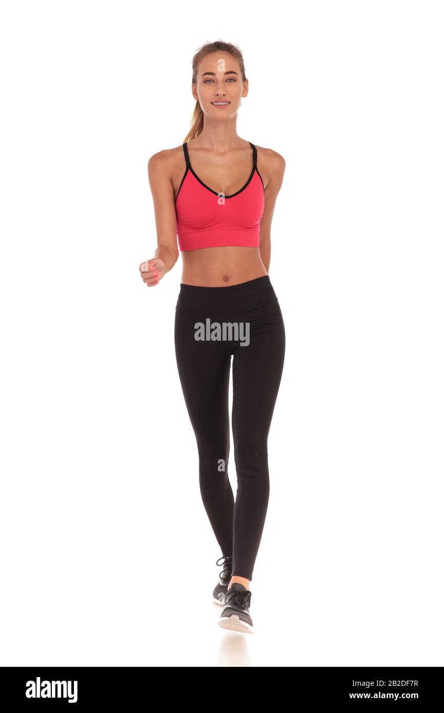 happy fitness young woman walking forward on white background Stock ...