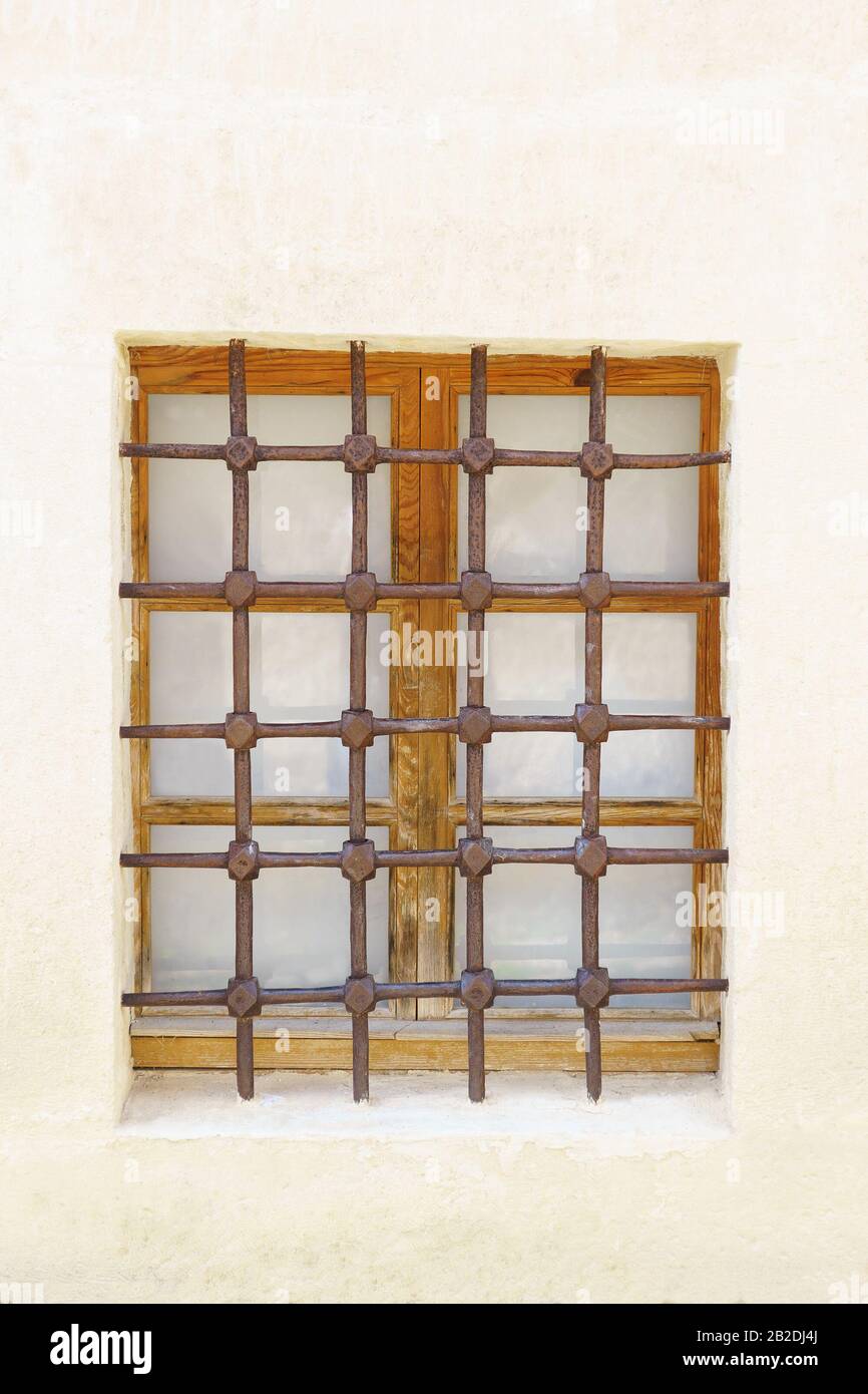 Metal grille with a geometric pattern on an old wooden window ...