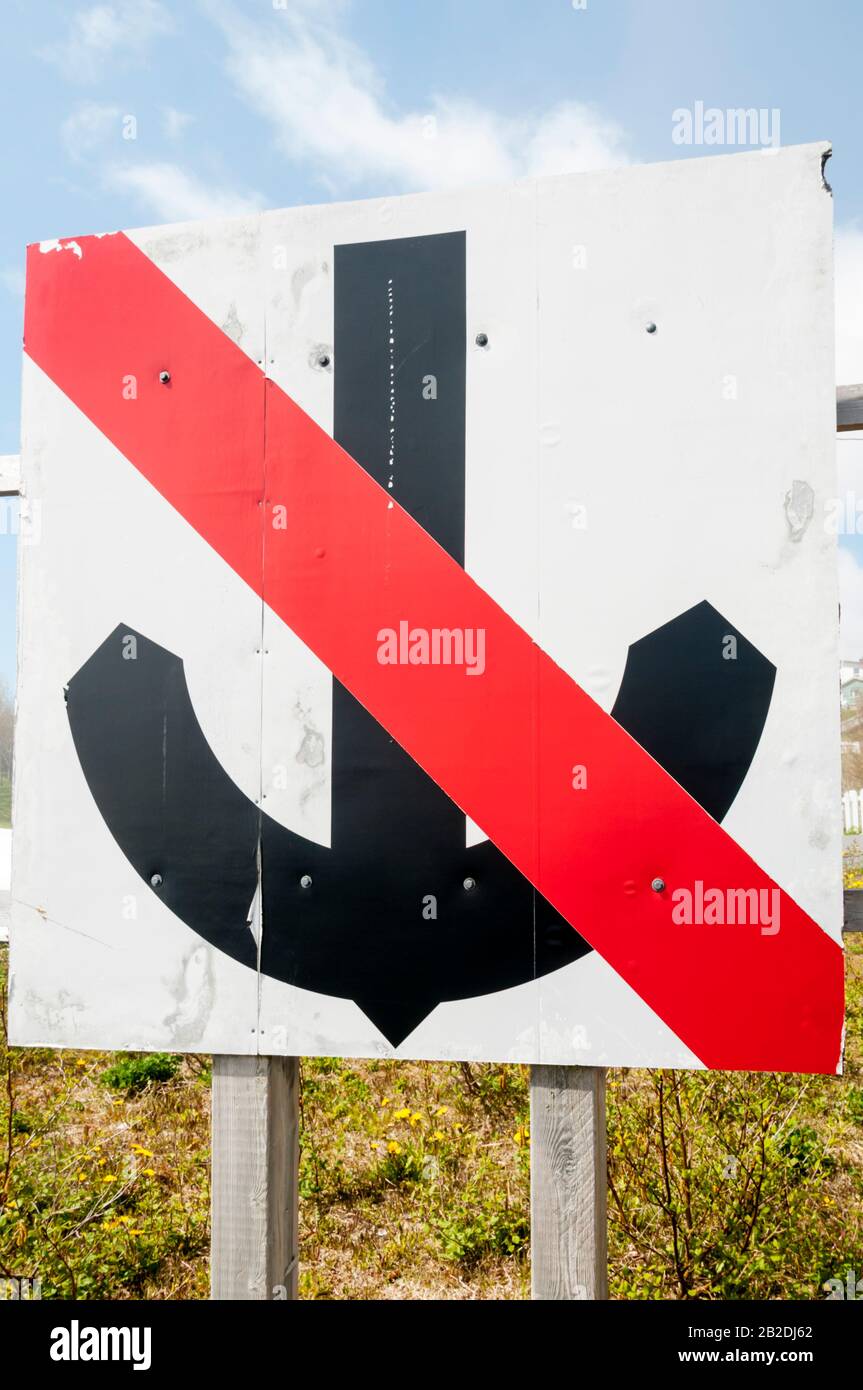 Wooden sign in harbour warning of area where it is unsafe to anchor ...