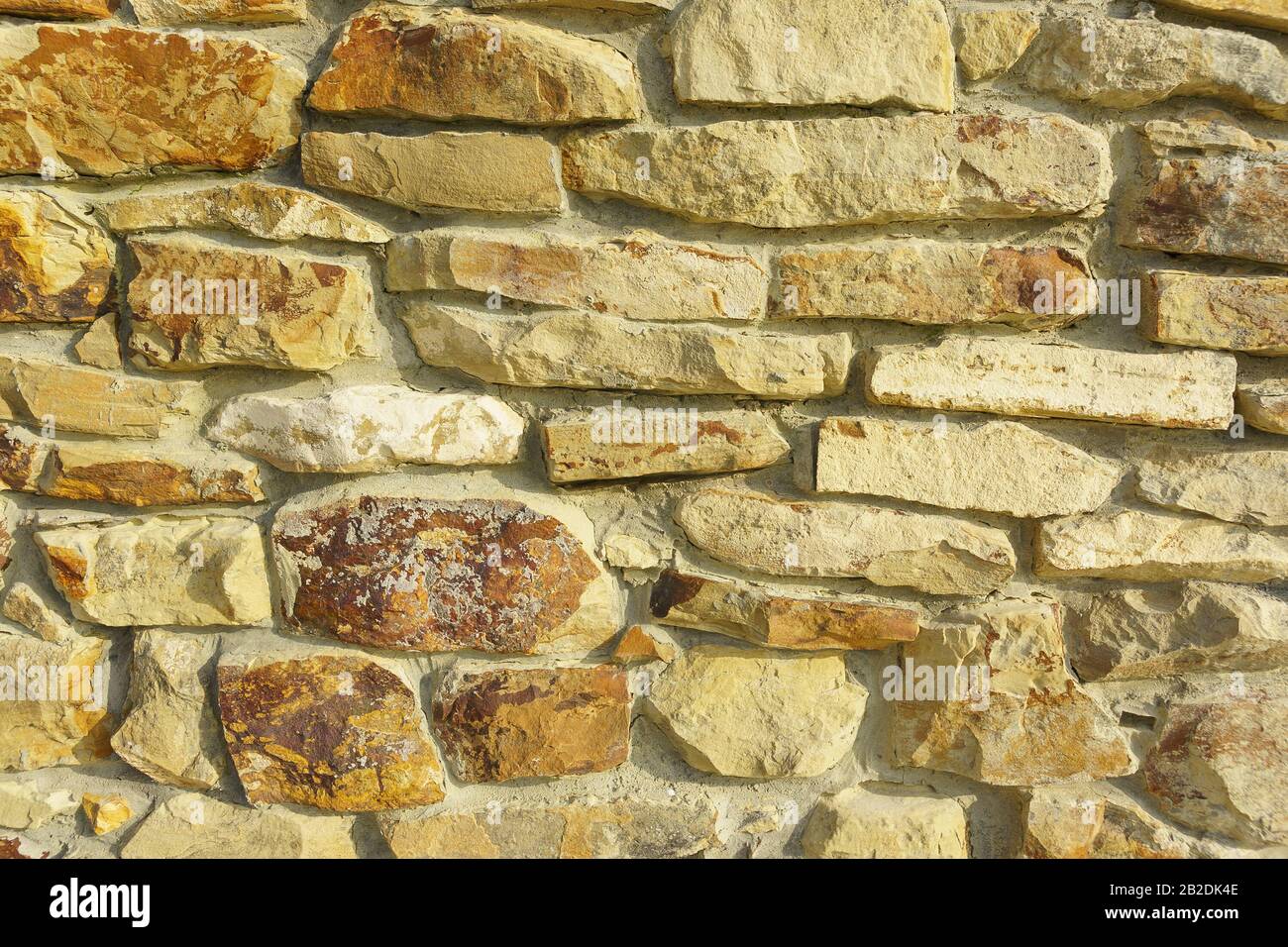 A strong stone wall from Sandstone. The natural texture. Background ...