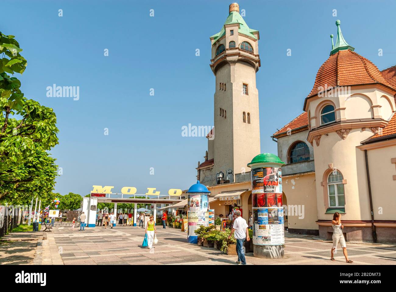 Beach promenade at the Molo pier with the lighthouse of Sopot, Poland ...
