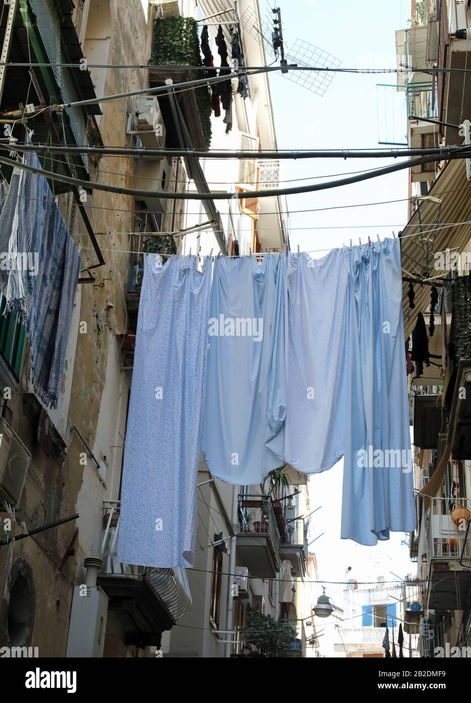 bedclothes hanging in Naples between houses Stock Photo - Alamy