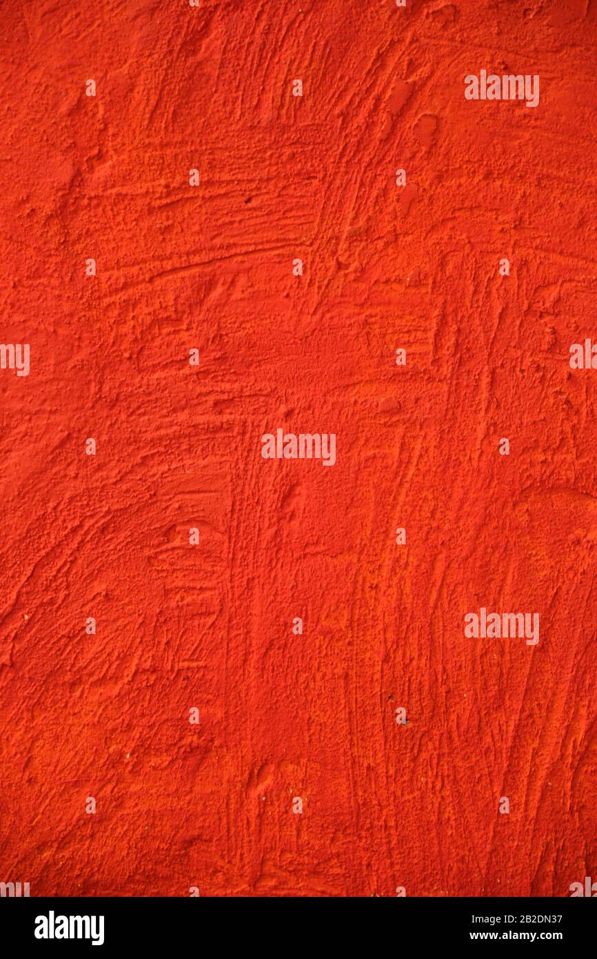 Textured stone wall painted with bright scarlet paint Stock Photo - Alamy