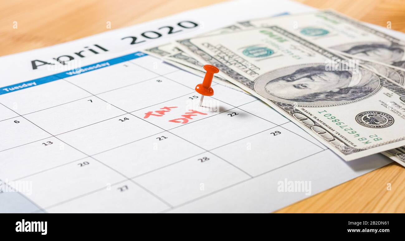 Red pin marked at April 15 for tax day with dollars falling on 2020 ...