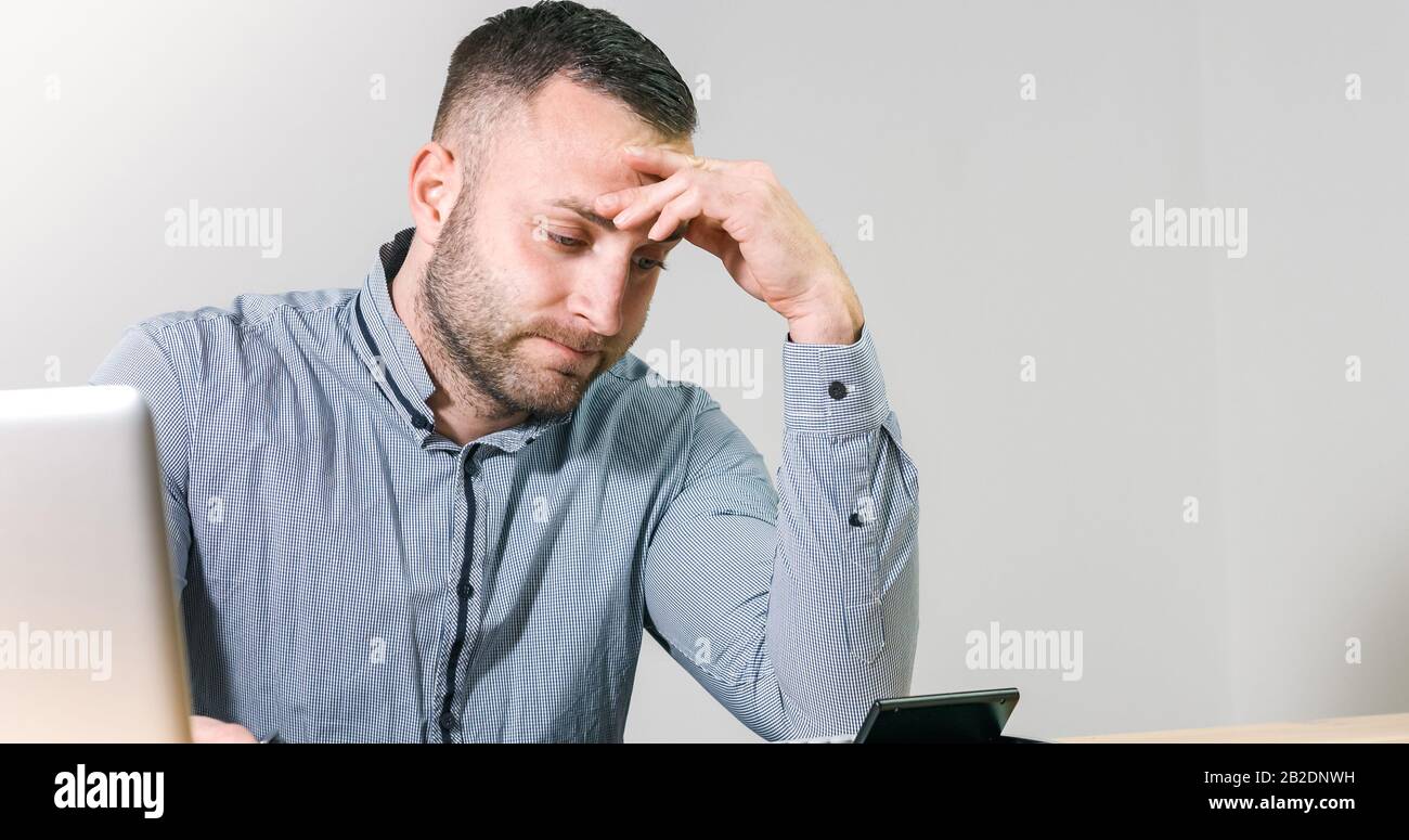 Frustrated businessman under stress nervously filling 1040 tax form ...