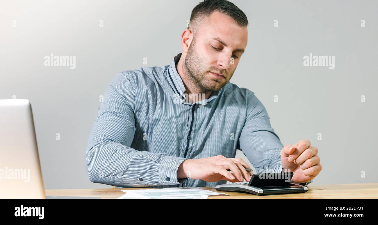 Frustrated businessman under stress nervously filling 1040 tax form ...