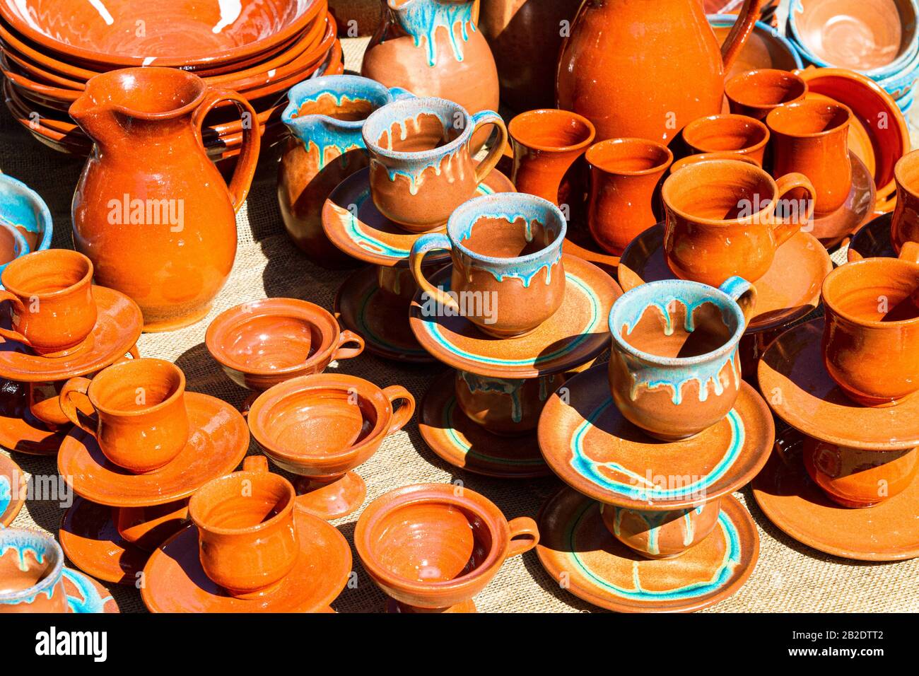 Handmade colorful ceramic cups, plates, pots, and cooking ware on sale ...