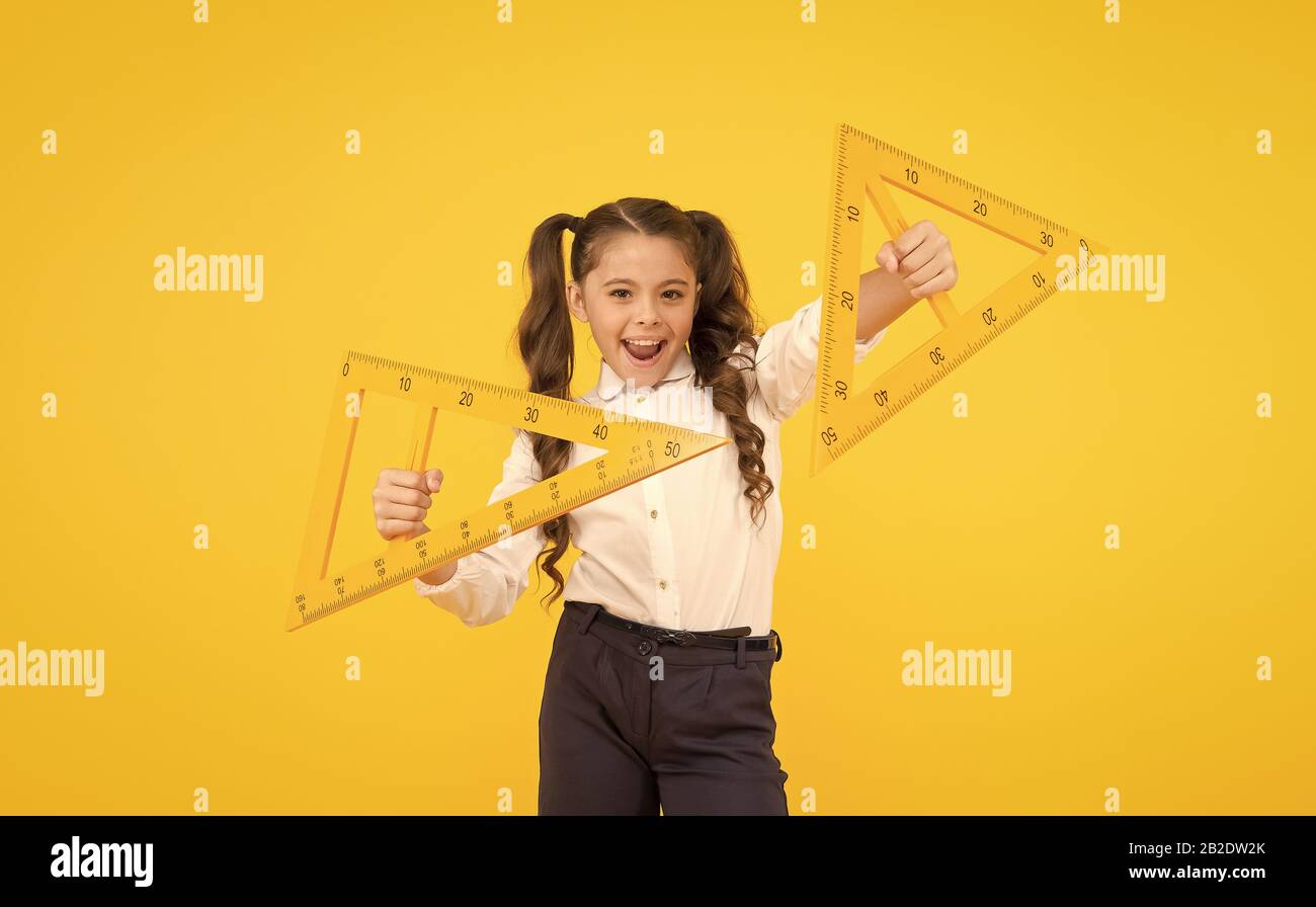 Exploring the properties of triangles in the lesson. Cute girl holding ...