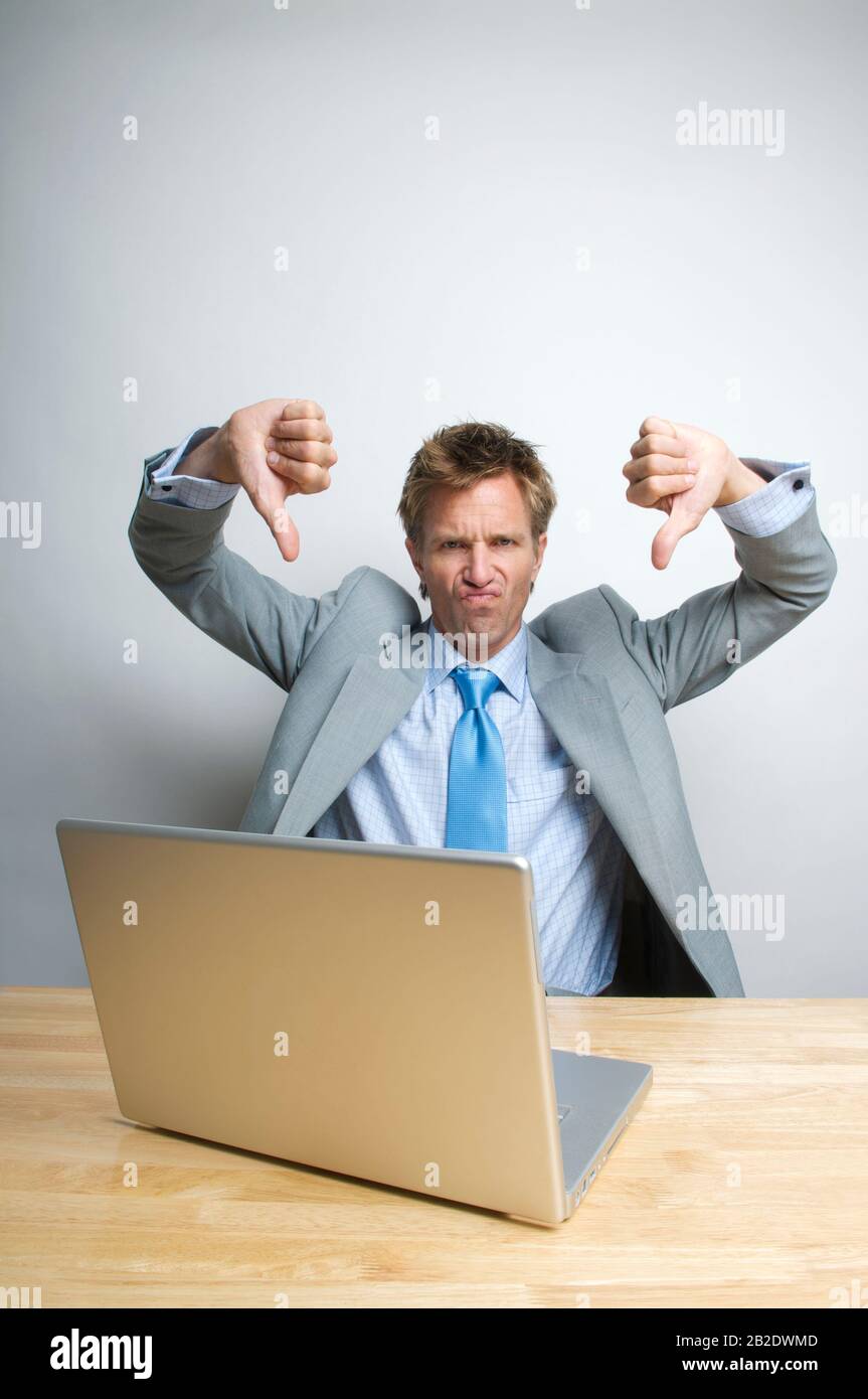 Frown businessman desk hi-res stock photography and images - Alamy