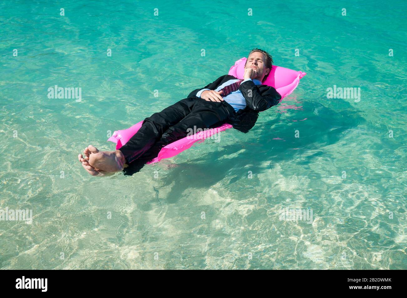 Pensive businessman thinking with hand on chin floating on a bright ...