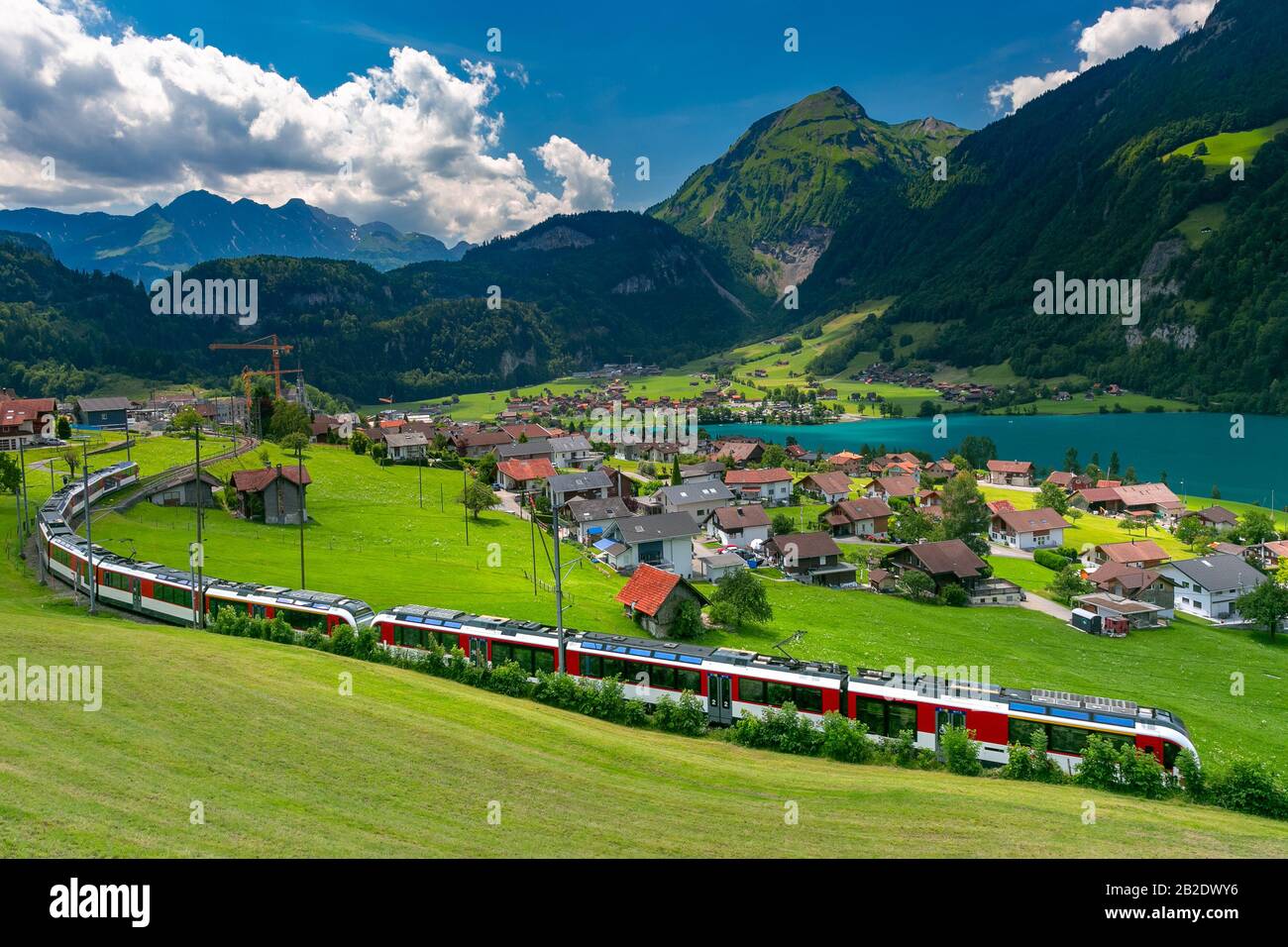 Famous electric red tourist panoramic train in swiss village Lungern ...