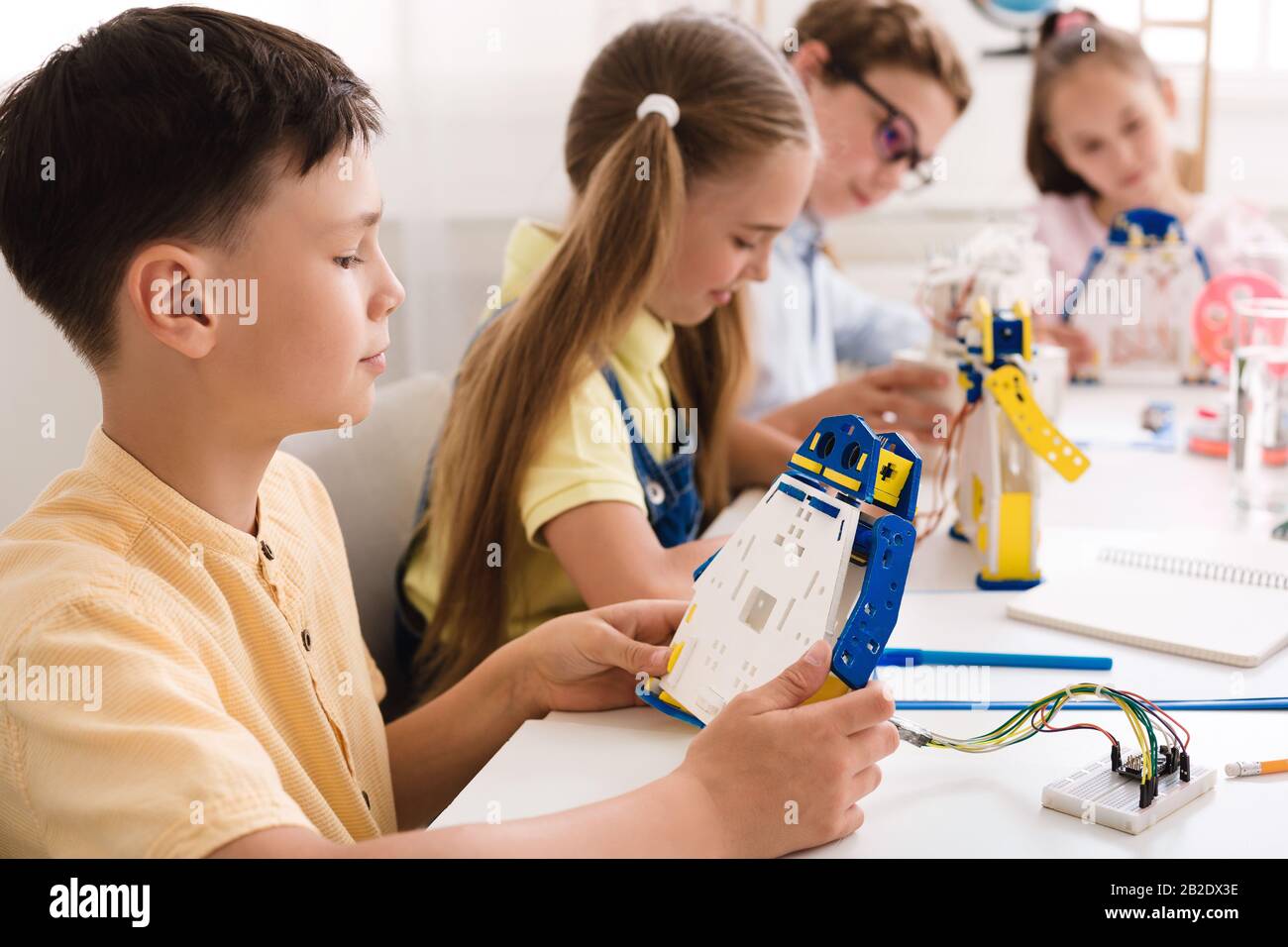 School boy working on project, making diy robot Stock Photo - Alamy