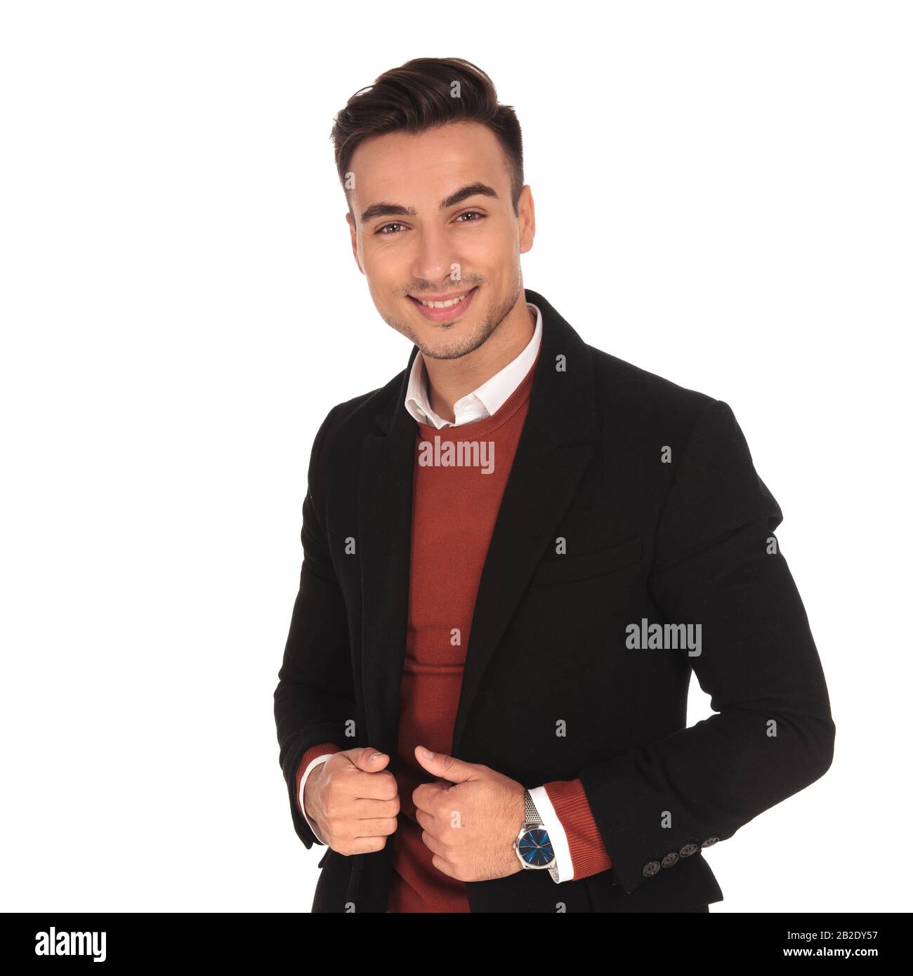young smart casual man smiling while holding his collar on white ...