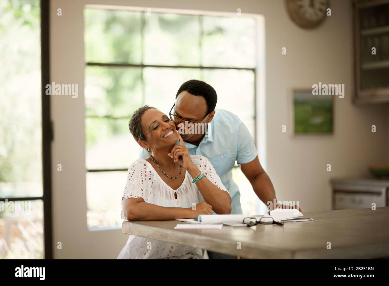 Affectionate husband kissing his smiling wife on the cheek Stock Photo ...