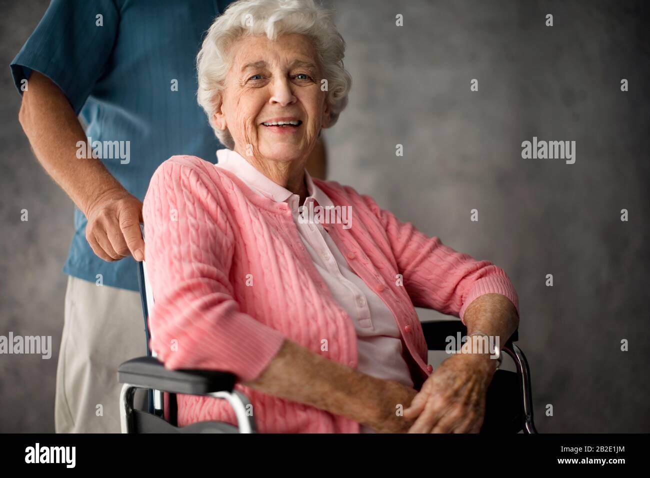 Mature woman in wheelchair assisted hi-res stock photography and images ...