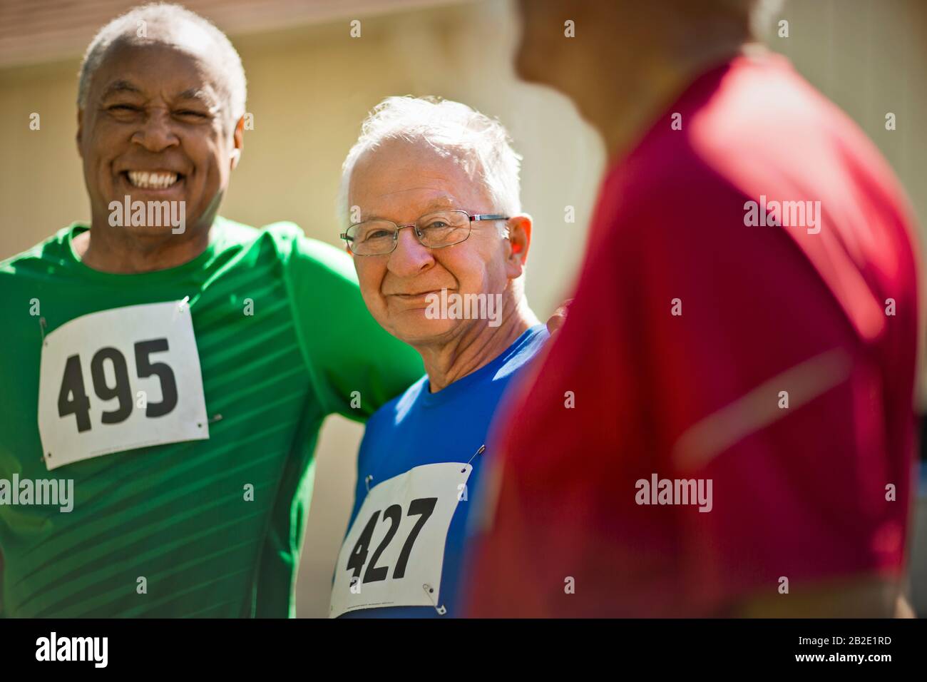 Three happy senior men standing together at an athletic event Stock ...