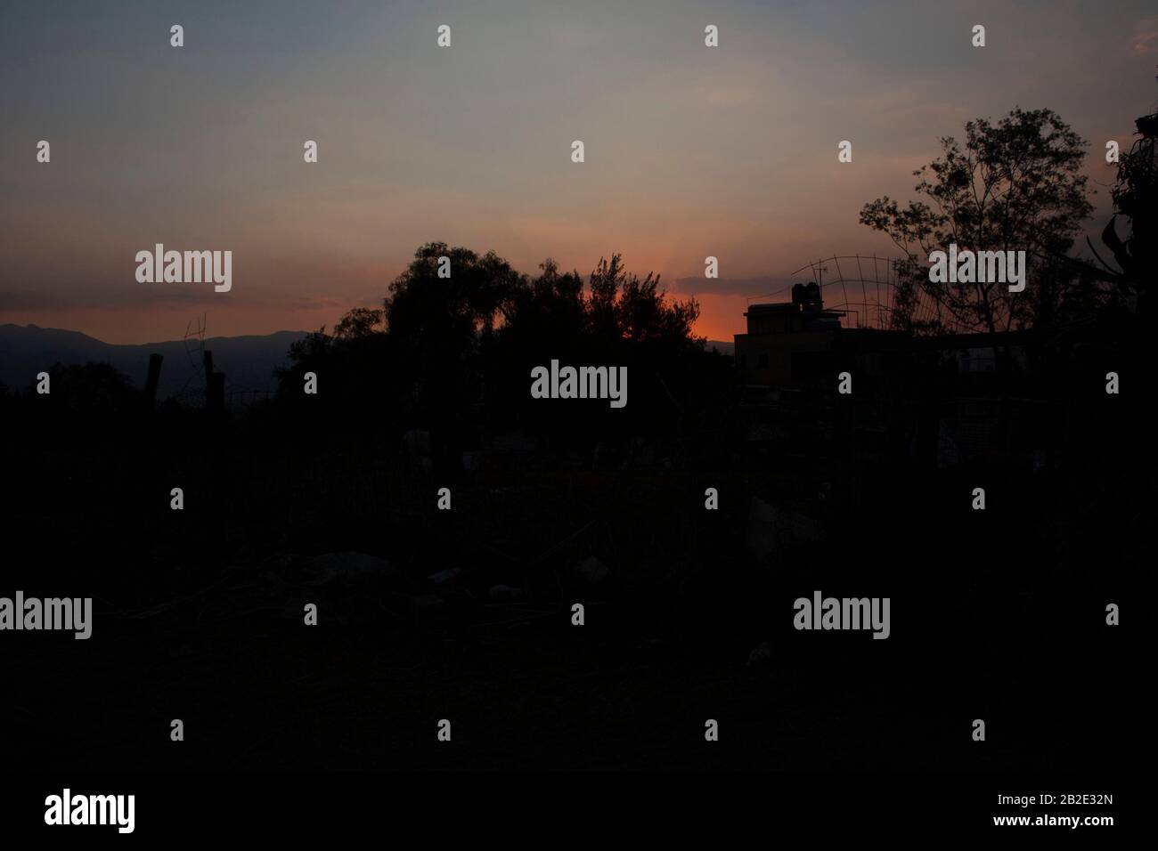 Sunset border between Cerro Estrella Park and the periphery of a city ...