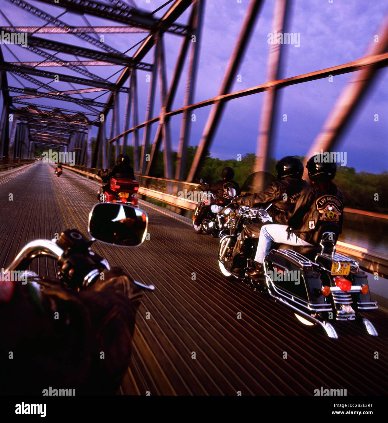 Convoy of motorcycles riding over a bridge Stock Photo - Alamy