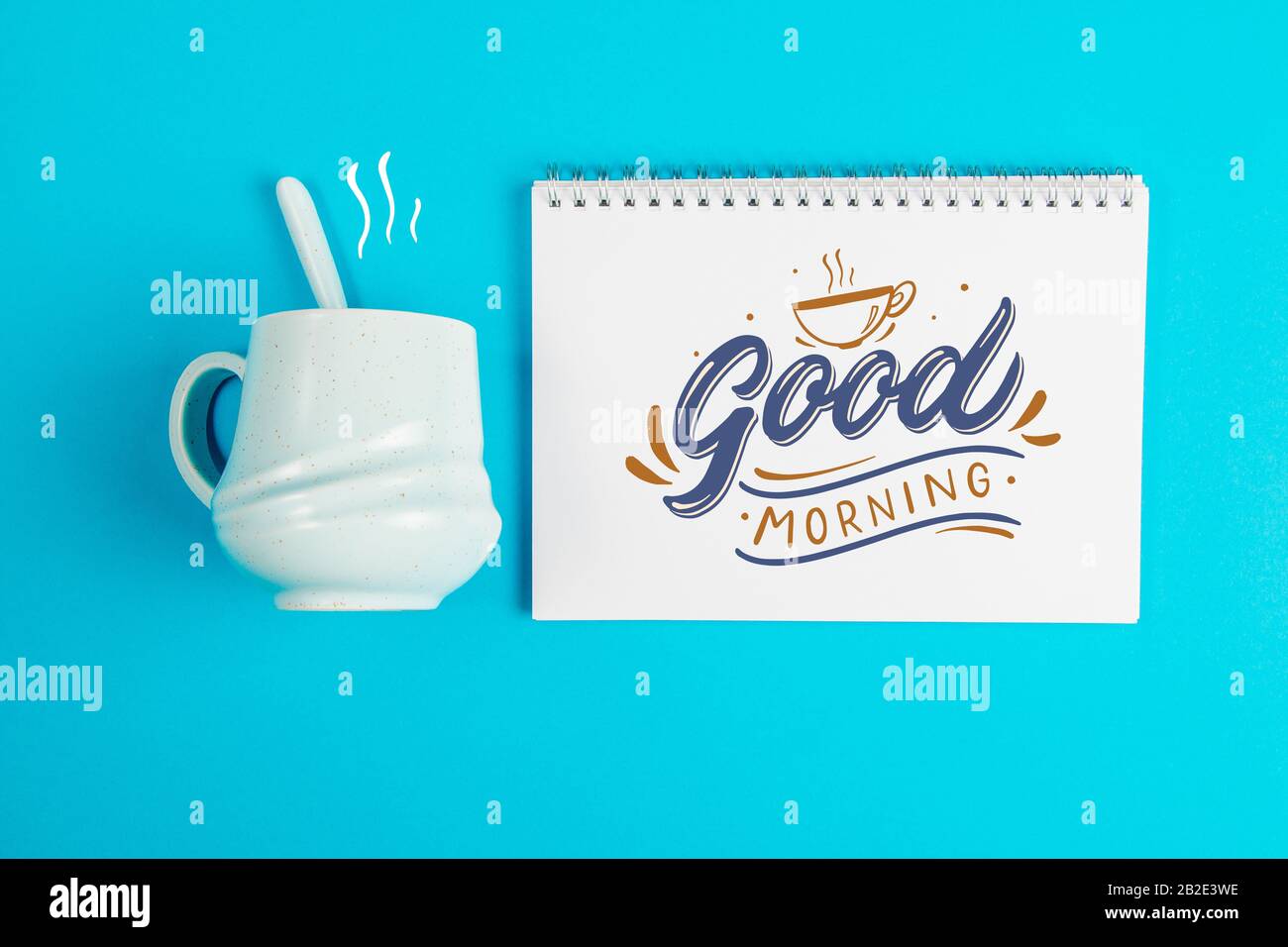 Blue coffee mug on a blue background with the text Good Morning Stock ...