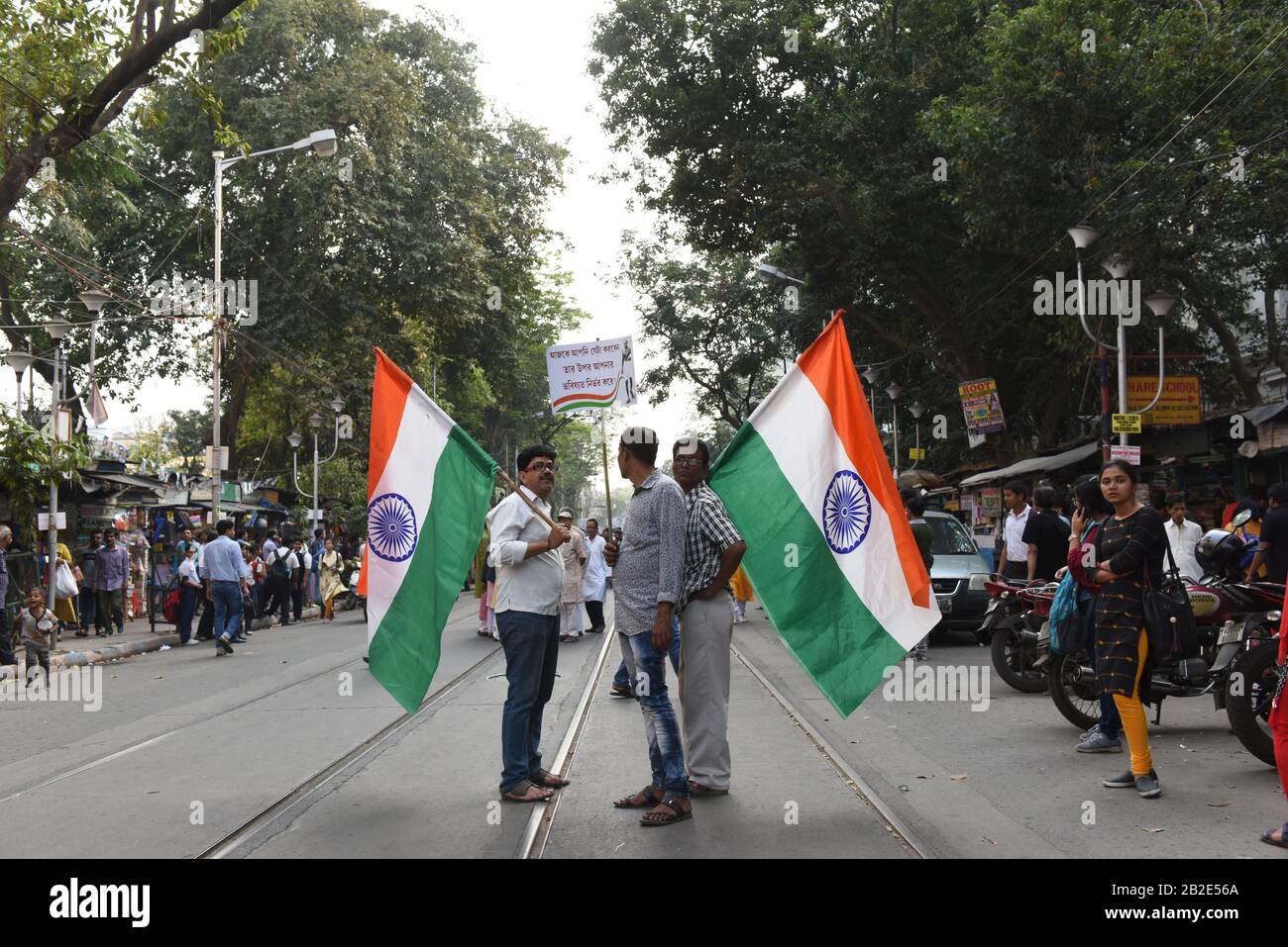Two men holding the Indian National flag in the middle of the street ...