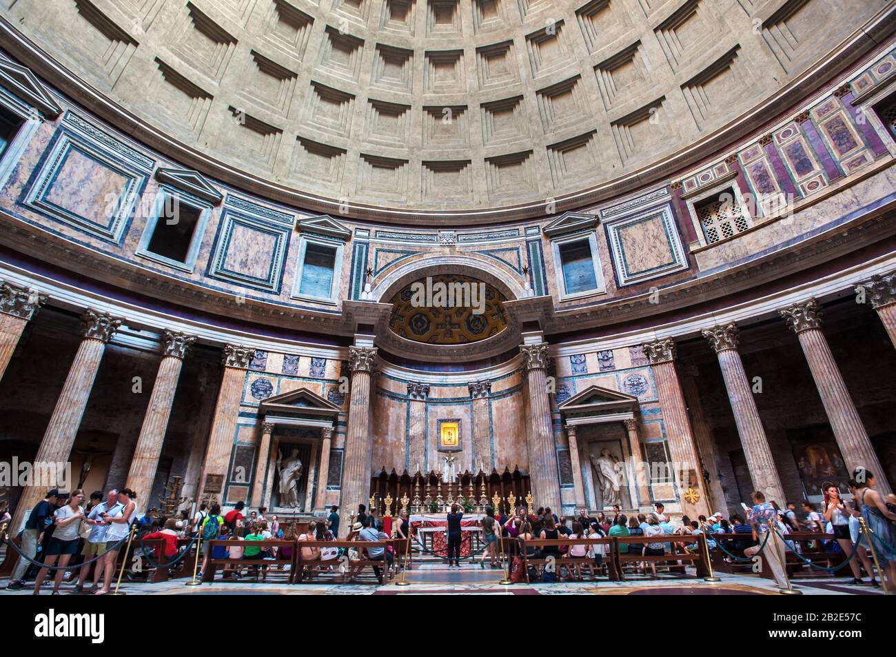 Tourists admire the altar and famous domed ceiling inside the Pantheon ...