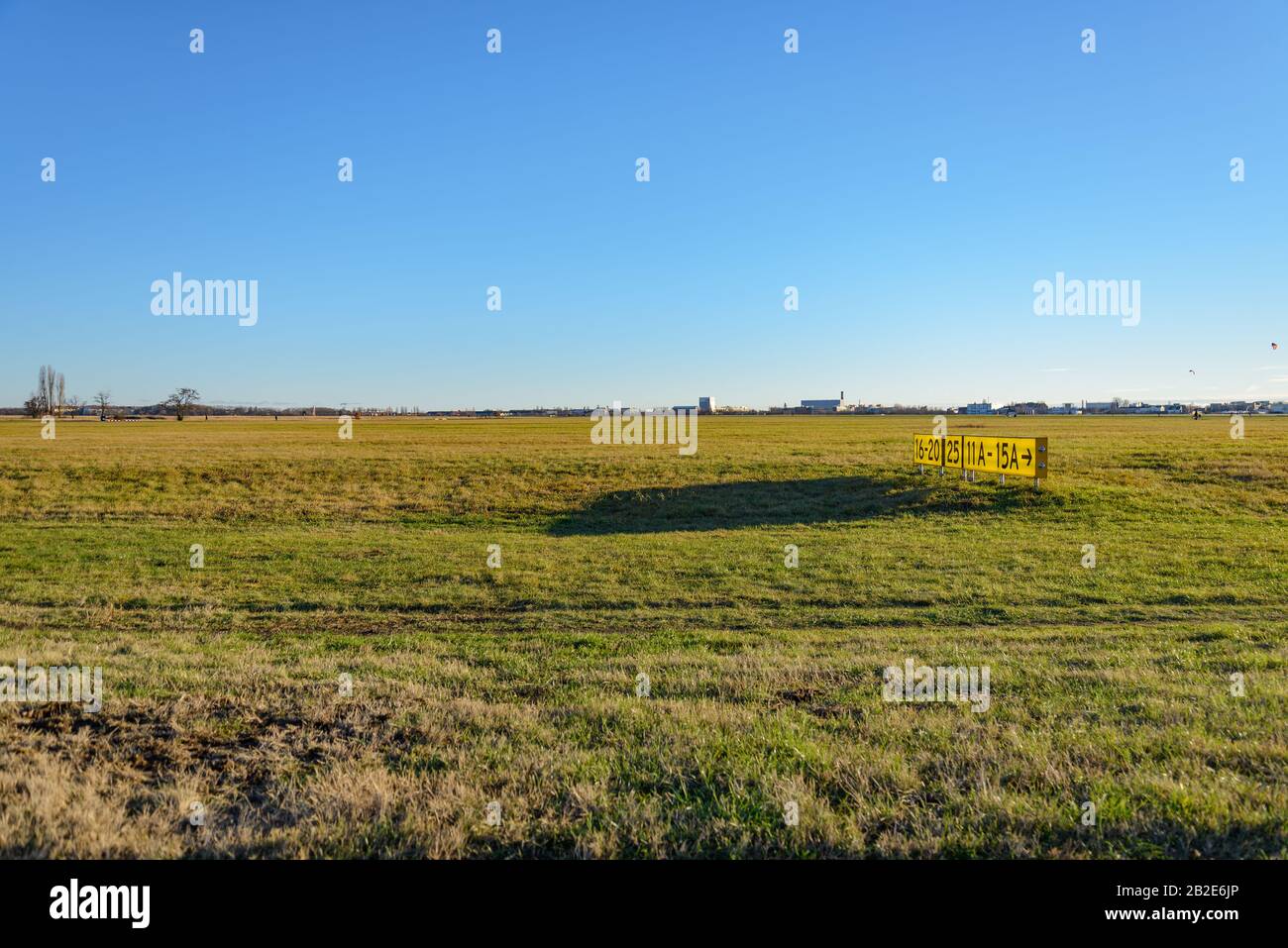 Grass field and old yellow signal number on the former landing field of ...