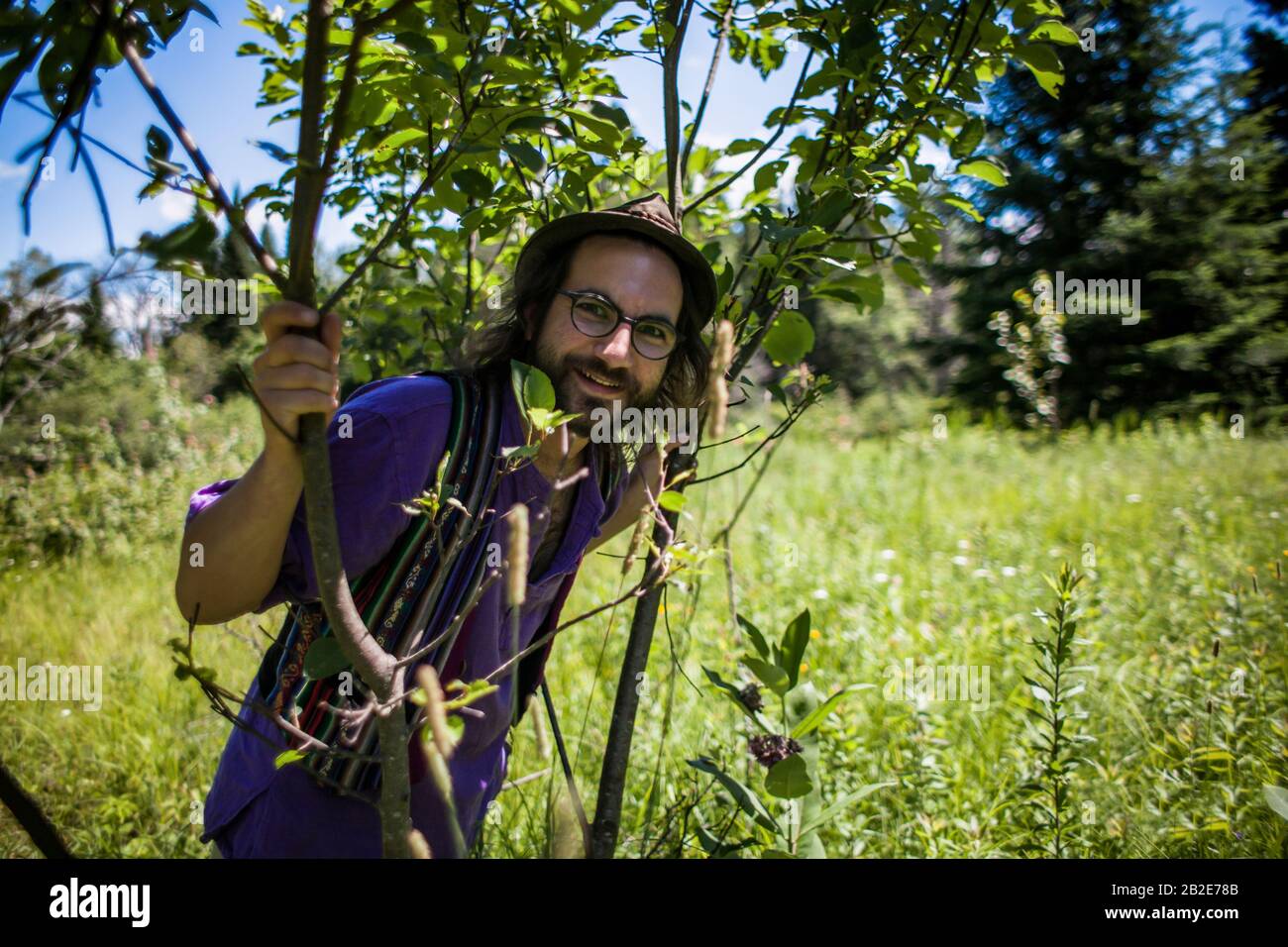 A bohemian storyteller tells a fascinating story in the forest in an ...