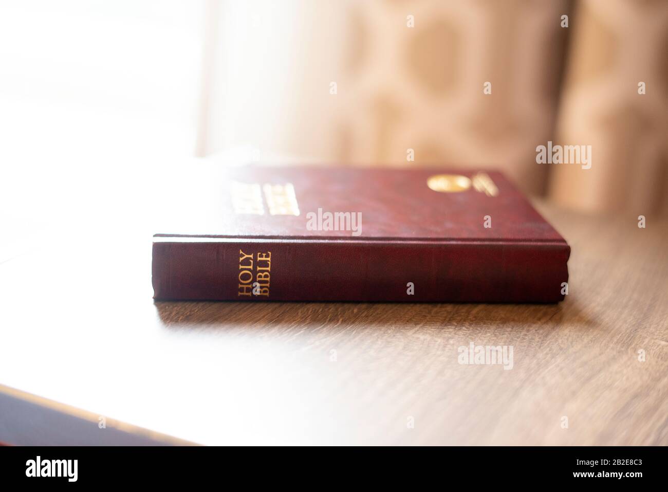 Back lit Holy Bible on side table in motel room Stock Photo - Alamy