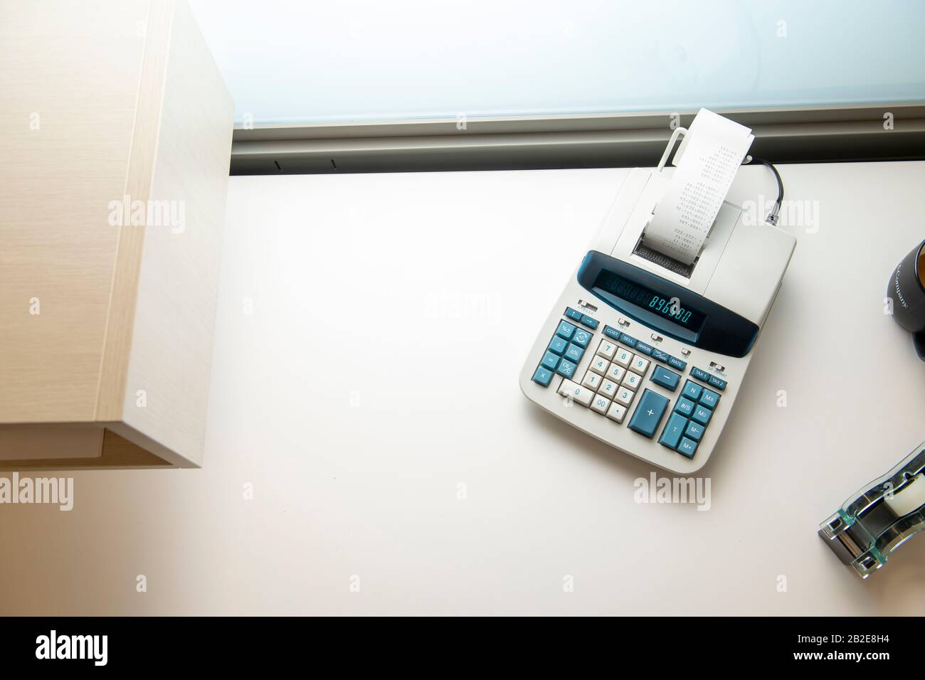 Adding machine on a sparse minimal office desk Stock Photo - Alamy