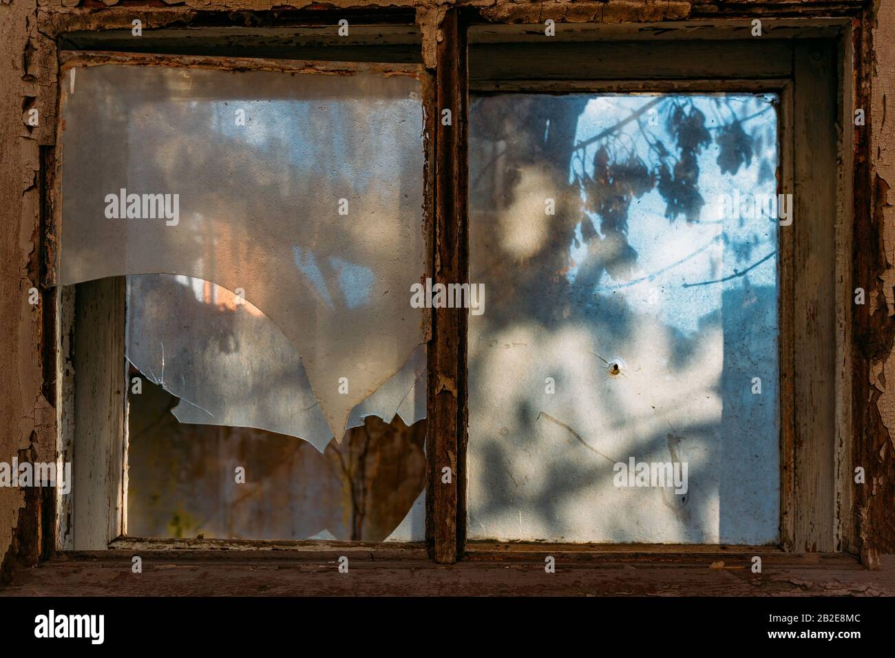 Broken window of old abandoned wooden building Stock Photo - Alamy