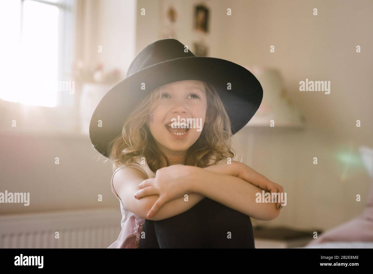 portrait of a young girl laughing wither face painted and fancy dress ...