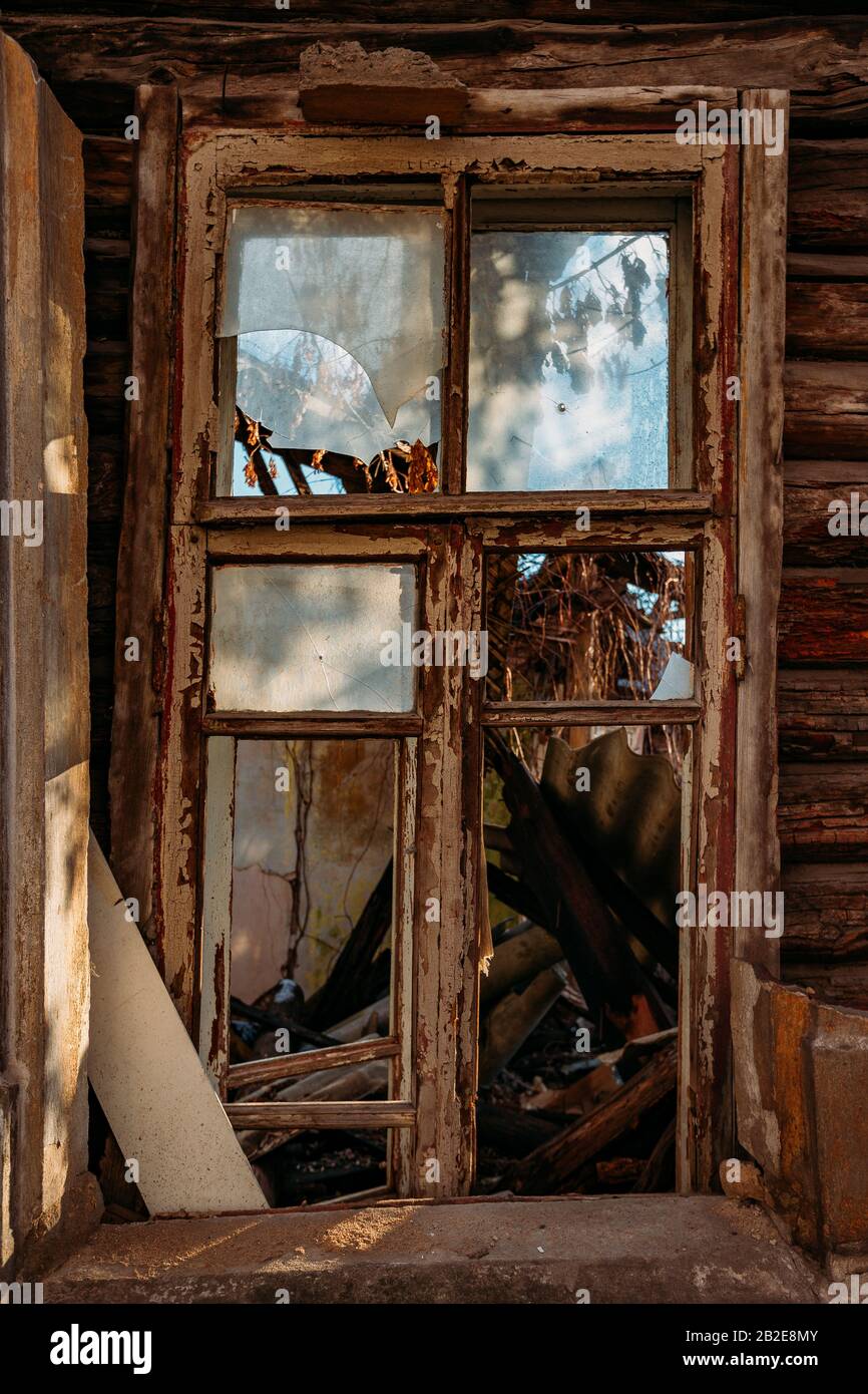 Broken window of old abandoned wooden building Stock Photo - Alamy