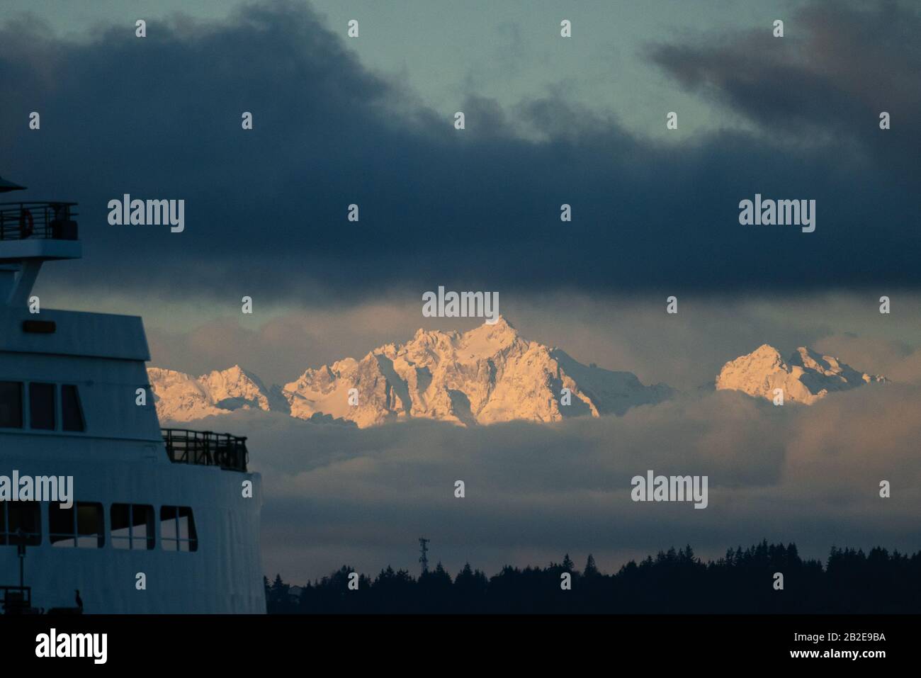 The Olympic Mountain range through the clouds at sunrise from Seattle ...
