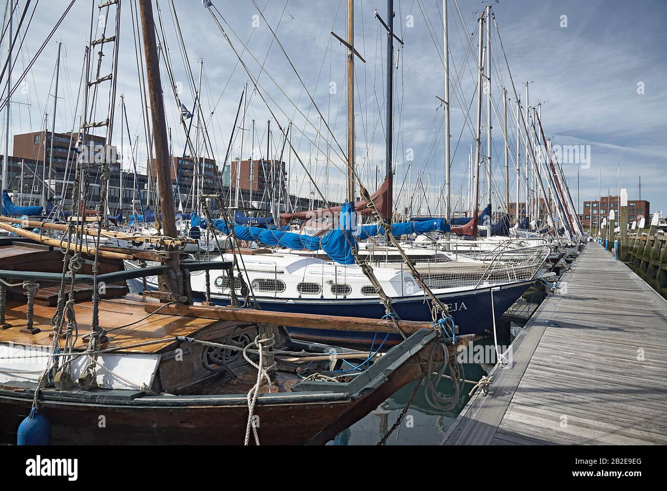 Sailing ships docked in the port along the jetty Stock Photo - Alamy