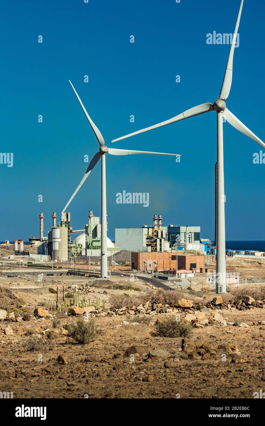 Thermal power station and a series of wind turbines near the sea coast ...