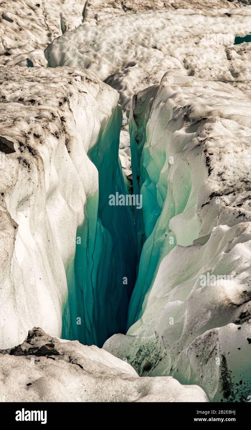 Brilliant blue colours of the inside of the deep crevice while hiking ...