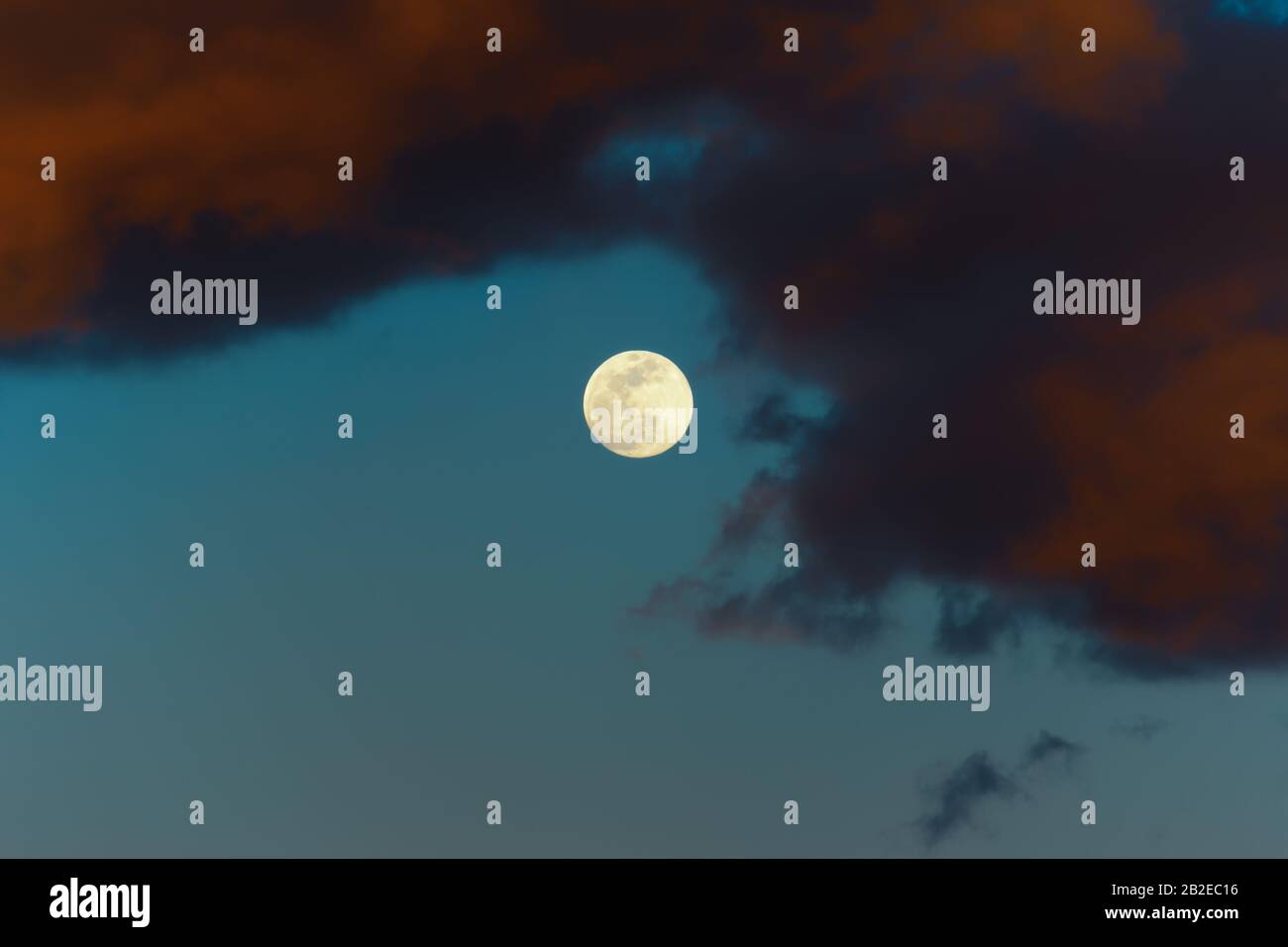 Abstract landscape. Dramatic night sky. Dark red clouds, and bright ...