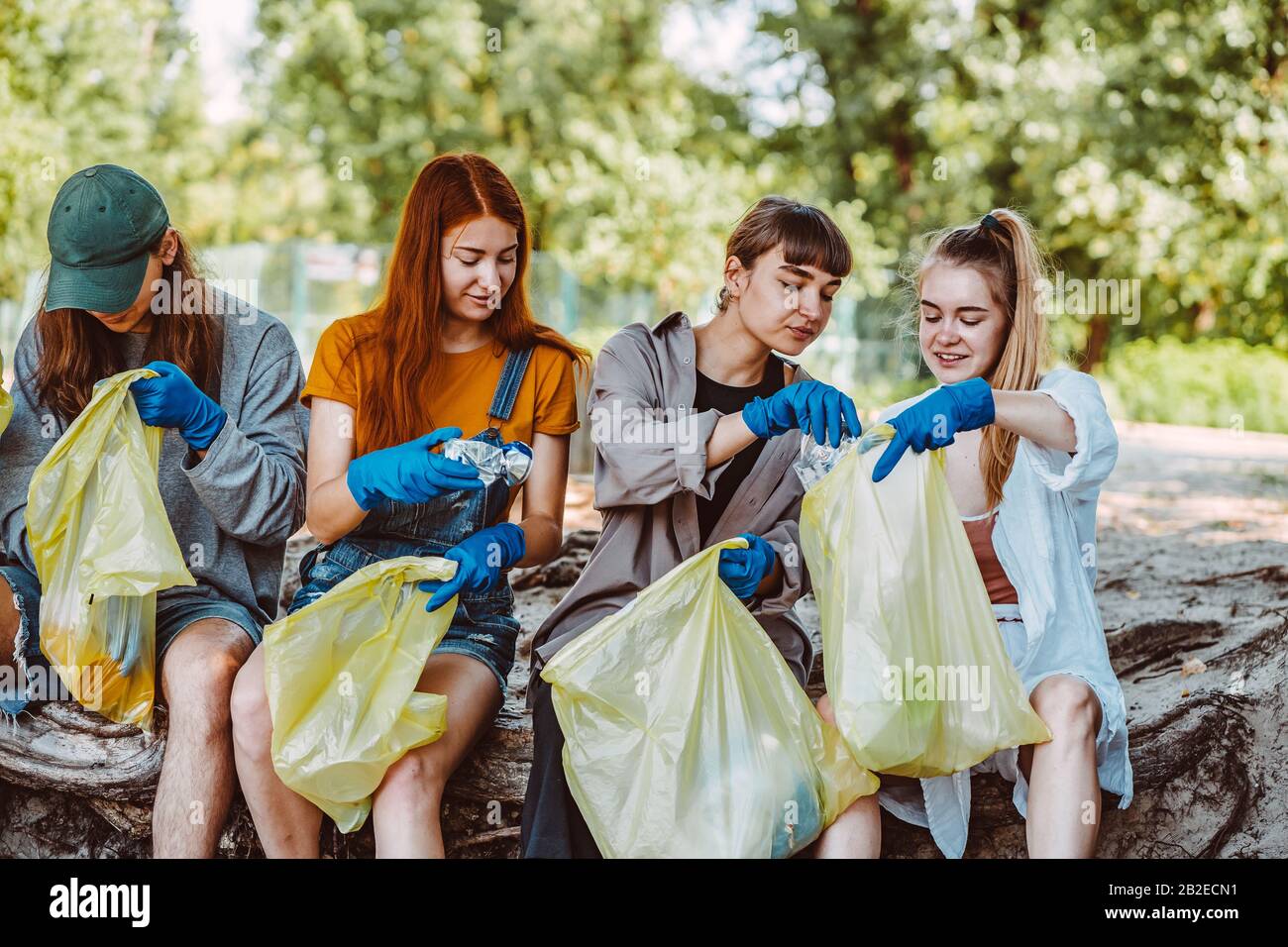 Group of activists friends collecting plastic waste at the park ...