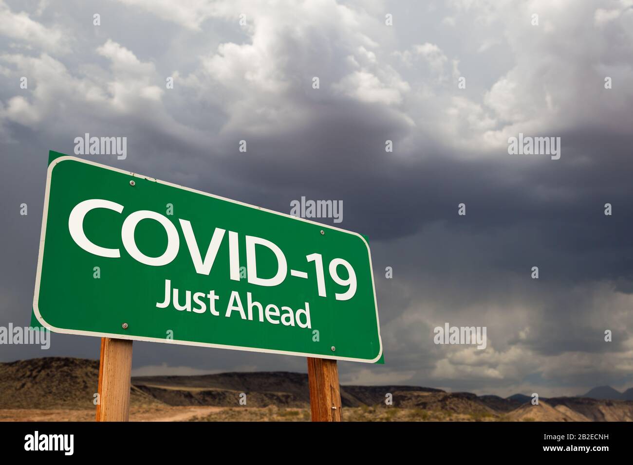 COVID-19 Coronavirus Green Road Sign Against Ominous Stormy Cloudy Sky ...