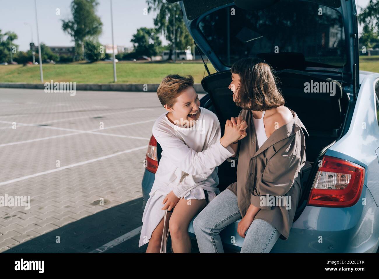 Two girls posing in car hi-res stock photography and images - Alamy