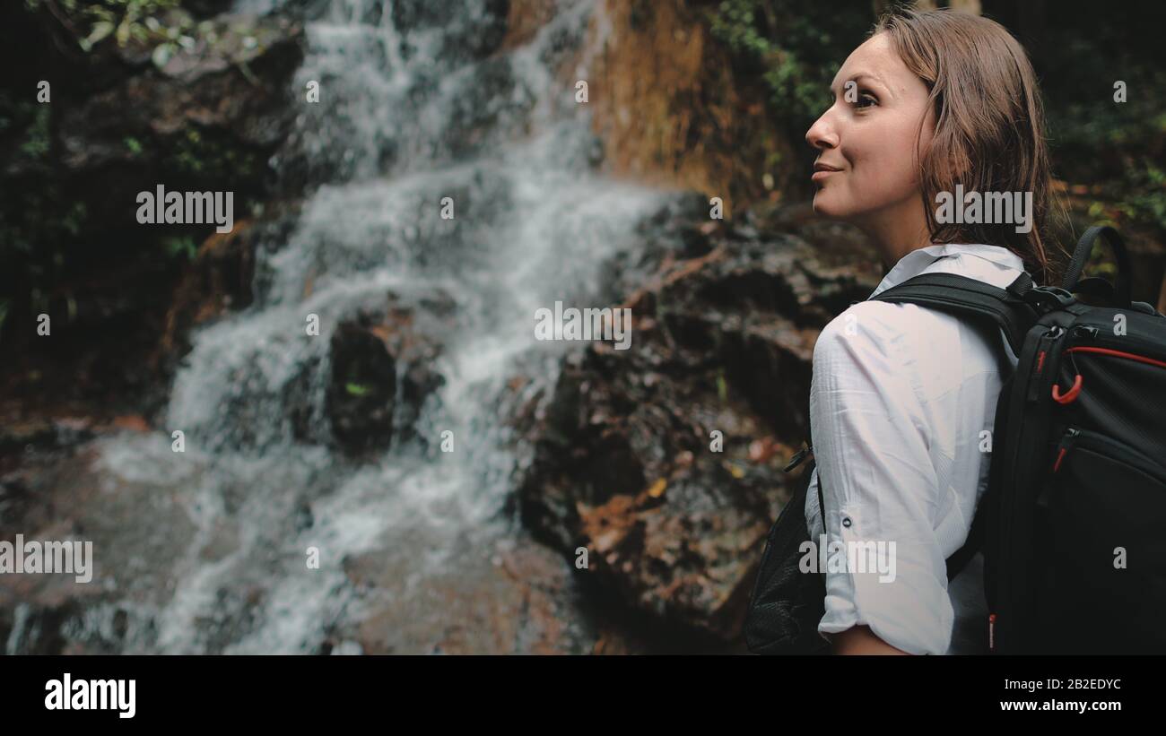 Girl Backpacker Look at Jungle Cascade Waterfall. Joyful Caucasian ...