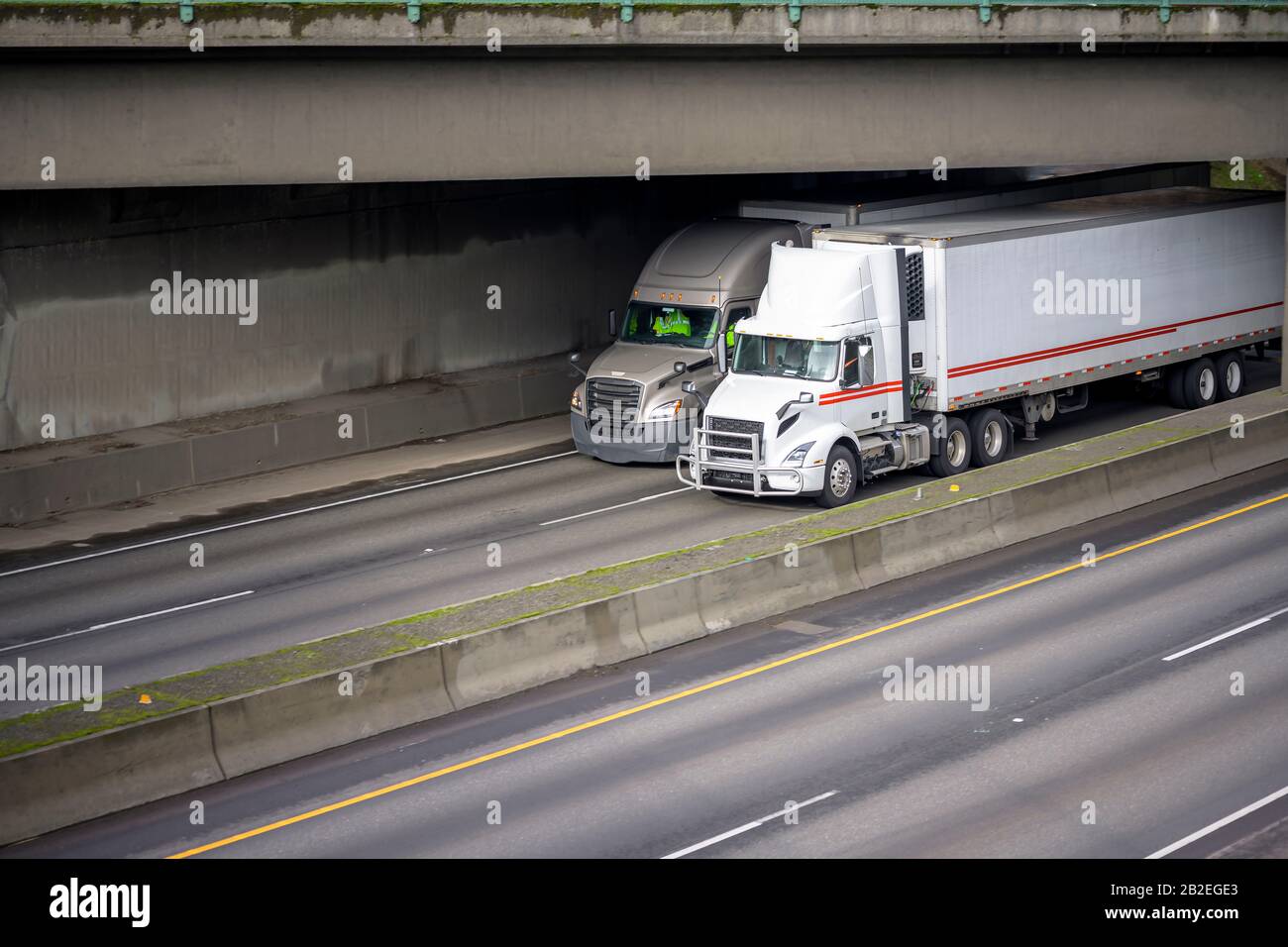 Two different industrial grade big rig semi trucks with diesel engines ...
