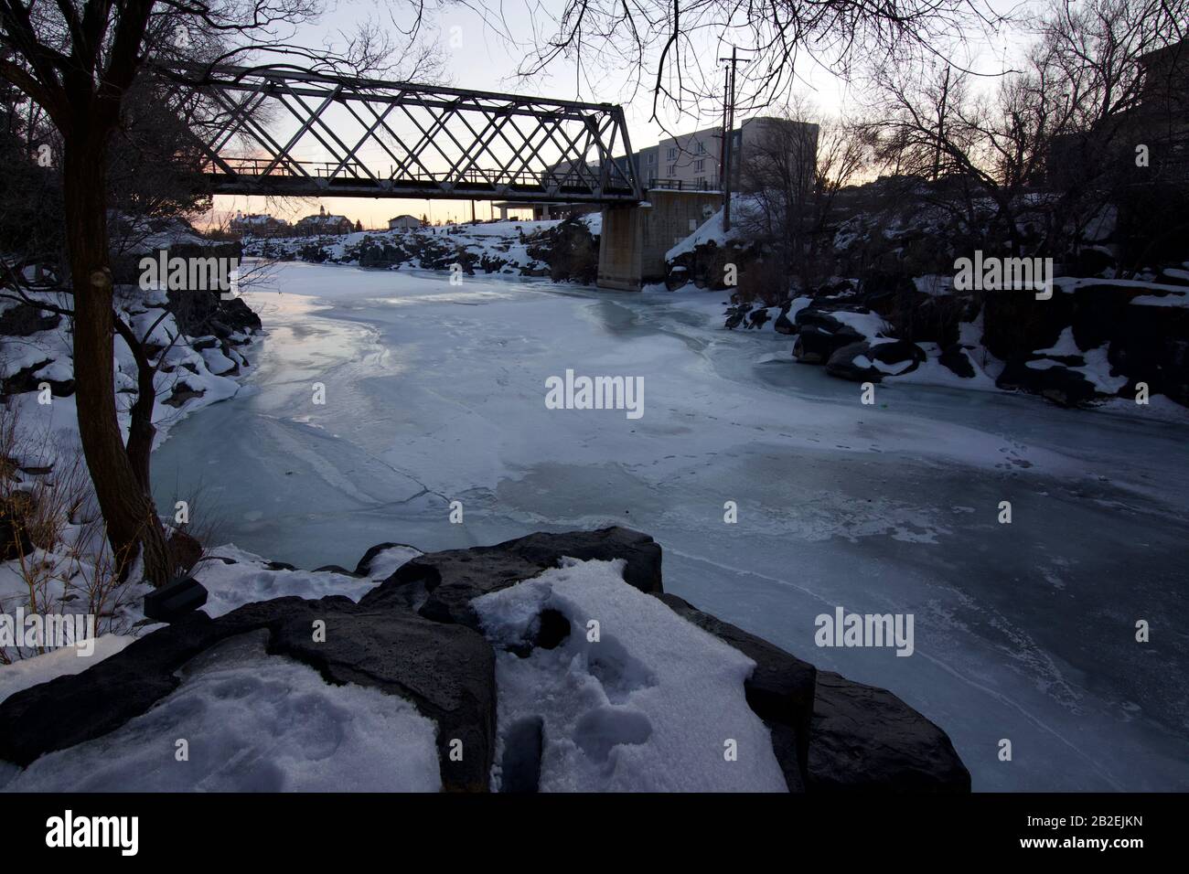 Frozen river with bridge Stock Photo - Alamy