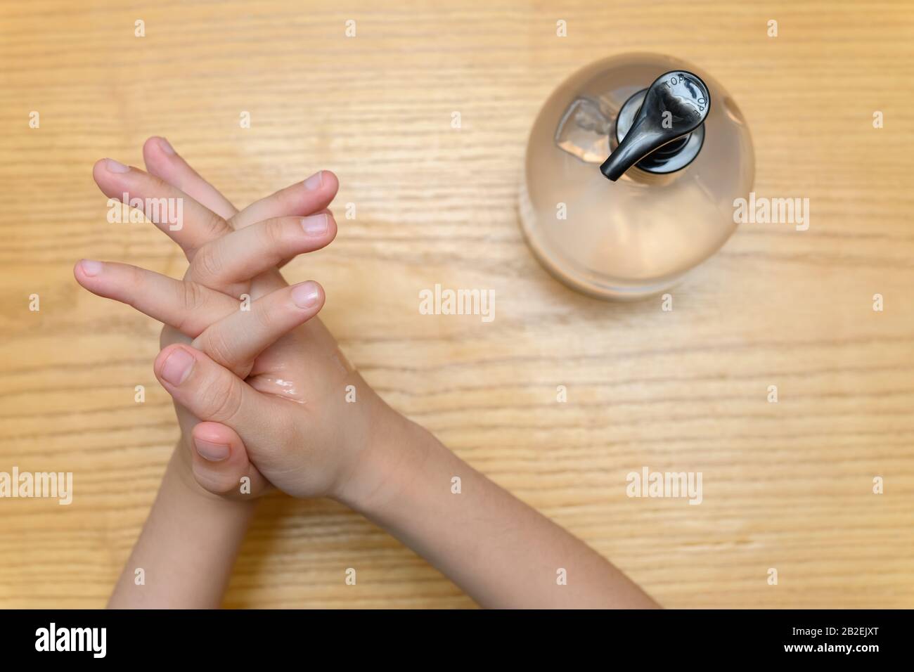 kid using instant hand sanitizer to clean his hands Stock Photo - Alamy
