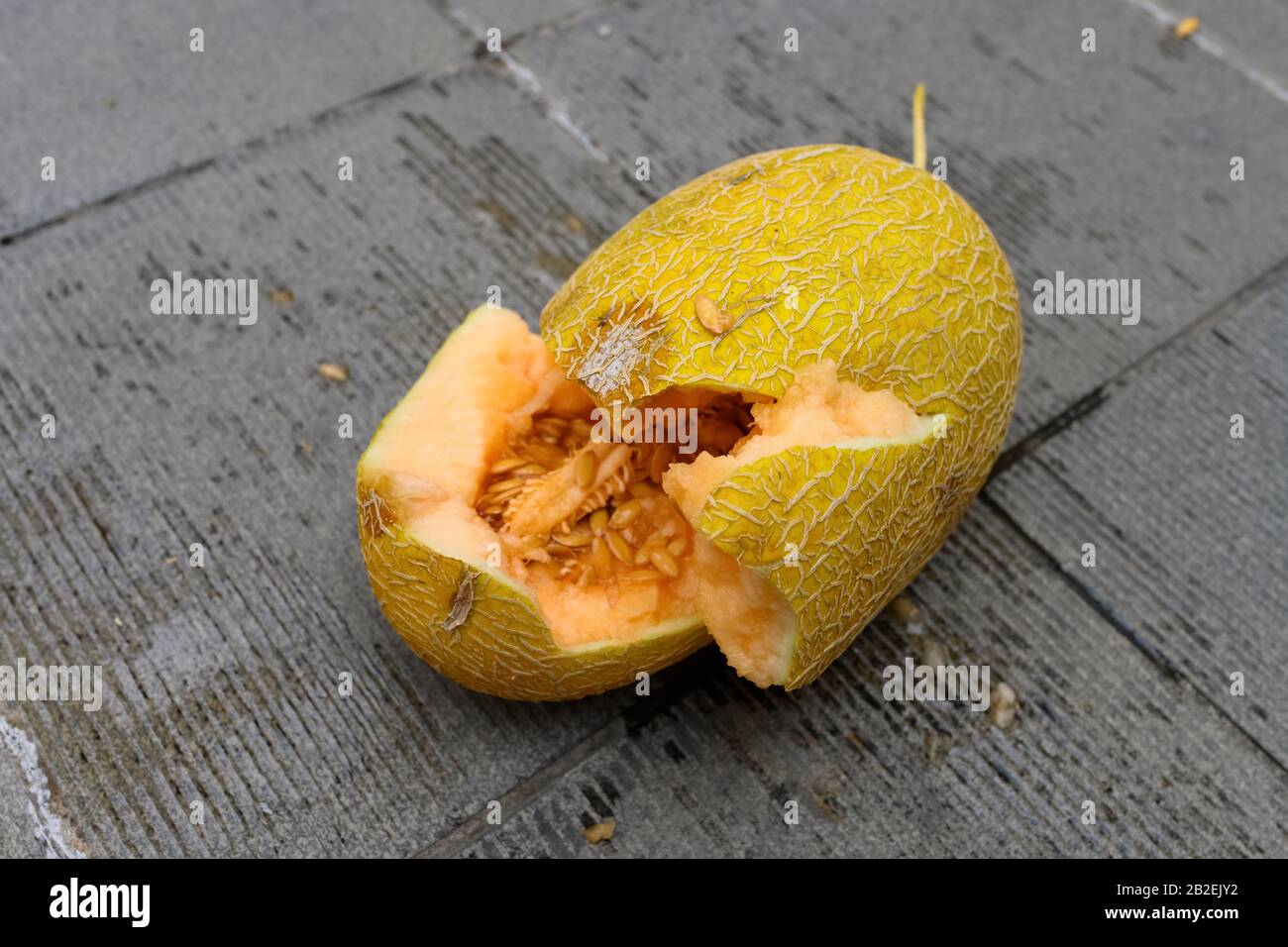 hami melon dropped to a concrete floor and broken Stock Photo - Alamy