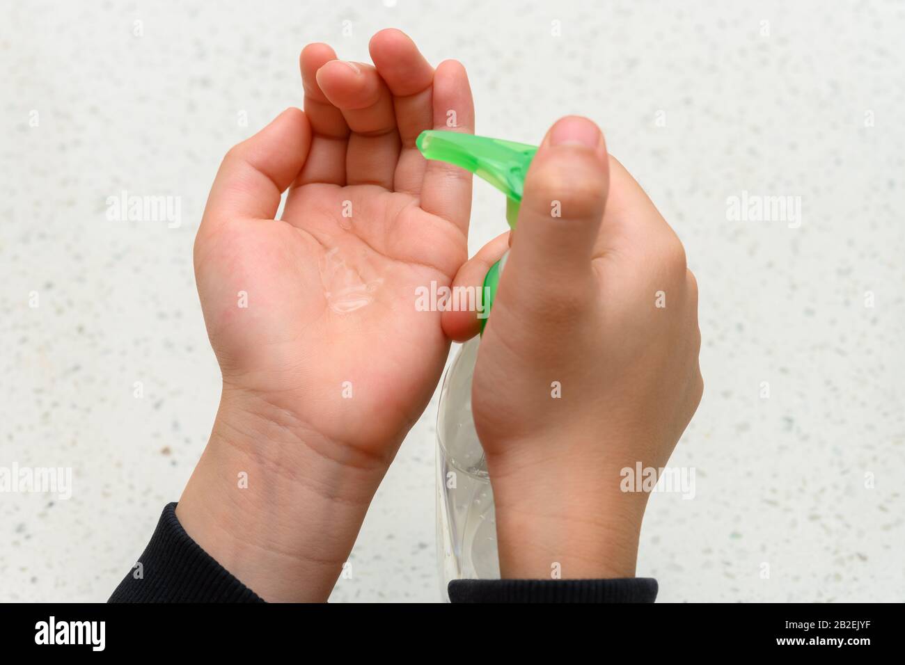 kid using instant hand sanitizer to clean his hands Stock Photo - Alamy