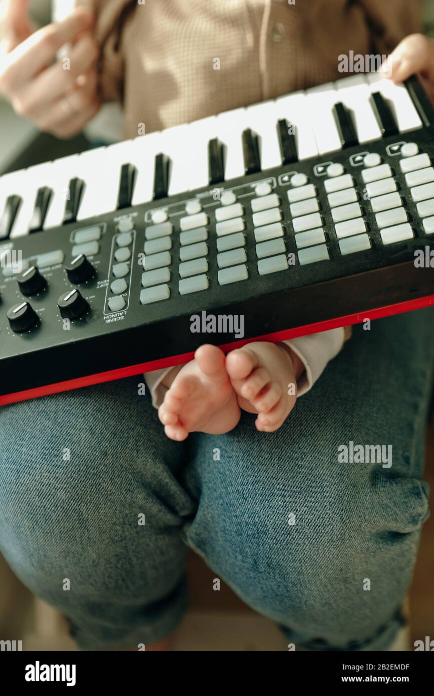 baby feet and piano. musical baby concept Stock Photo - Alamy