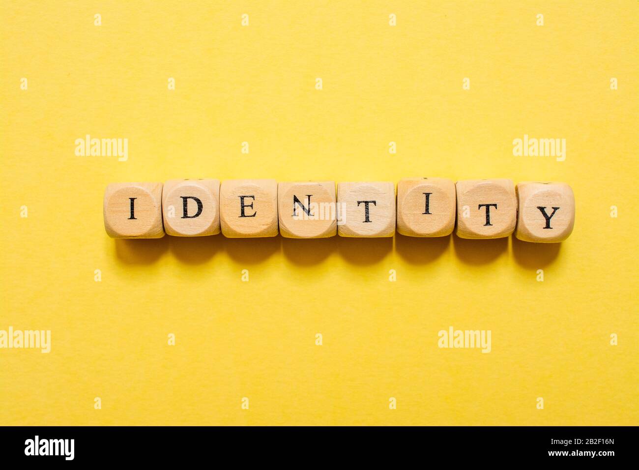 the word Identity, text made with dice on yellow background Stock Photo ...